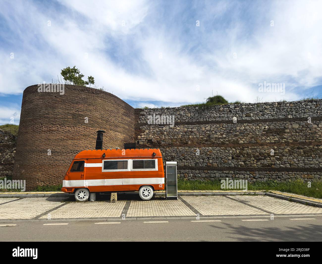 an old minibus in front of the historical place , blue sky in ...