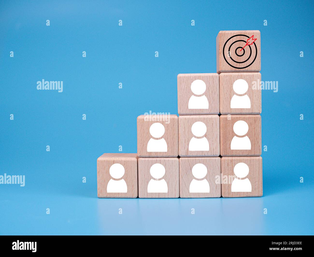 wooden block which prints a target icon and business symbol on white ...