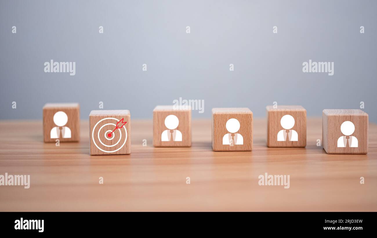 wooden block which prints a target icon and business symbol on white ...
