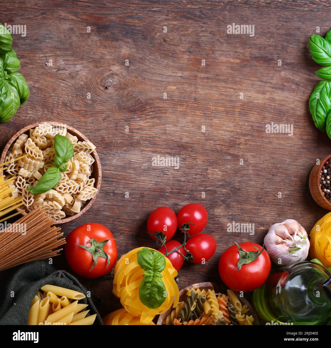 food background italian style pasta and basil on wooden background ...