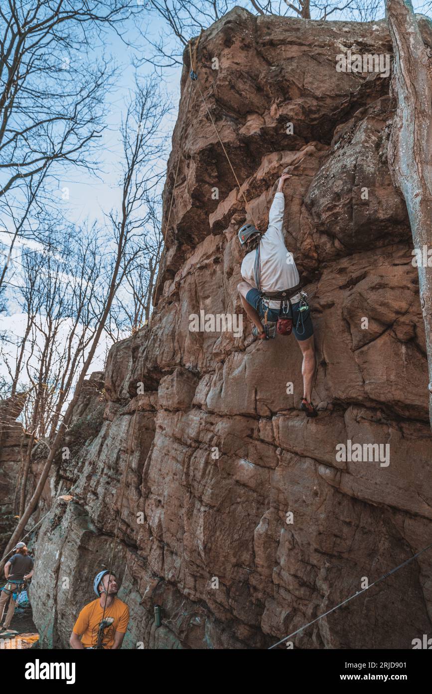 Two adventurous rock climbers in Western Pennsylvania scaling a rock ...