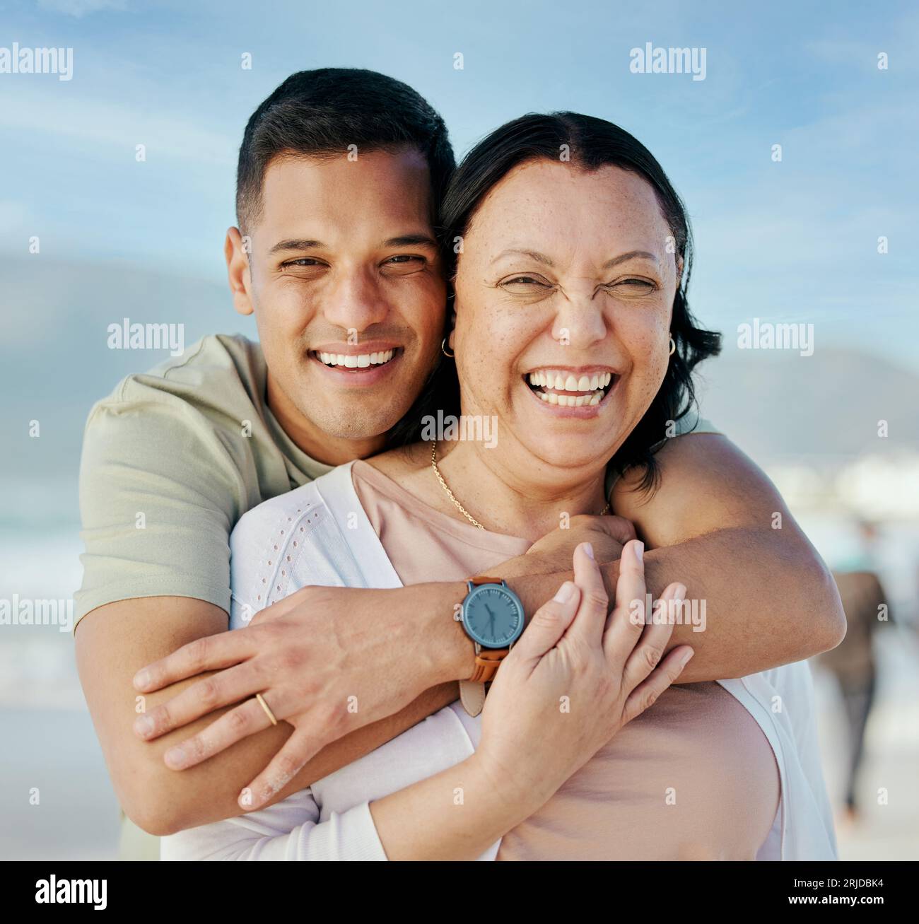 Portrait, hug and man with mother at beach happy, bond and relax in ...
