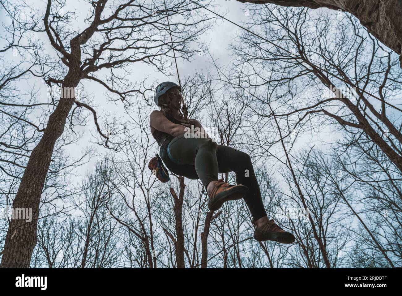 A woman is seen rock climbing in Western Pennsylvania, suspended from a ...