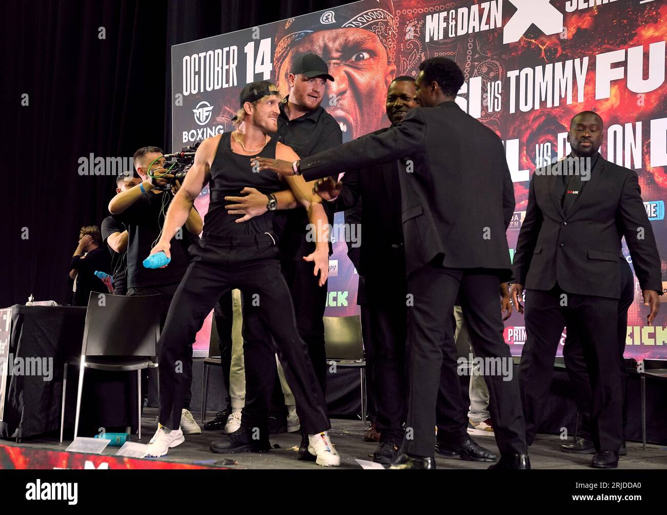 Logan Paul is held back during a press conference at the OVO Arena ...