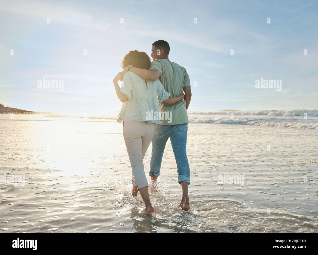 Love, hug and back of couple at the beach walking, bond and relax in ...