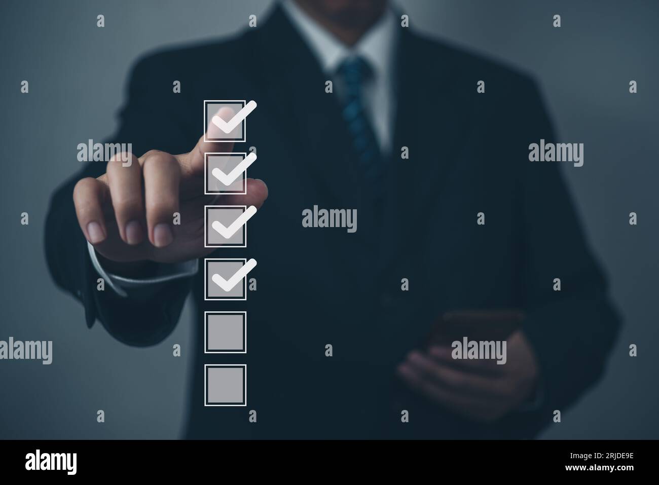 businessman using a virtual screen to check his to-do list. checking ...