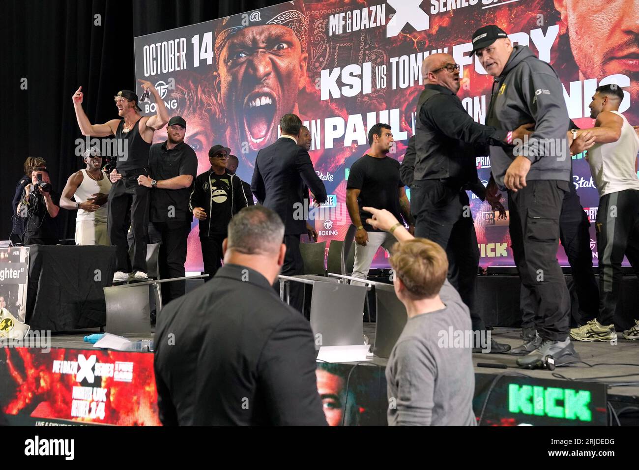 John Fury flips over tables on stage during a press conference at the ...