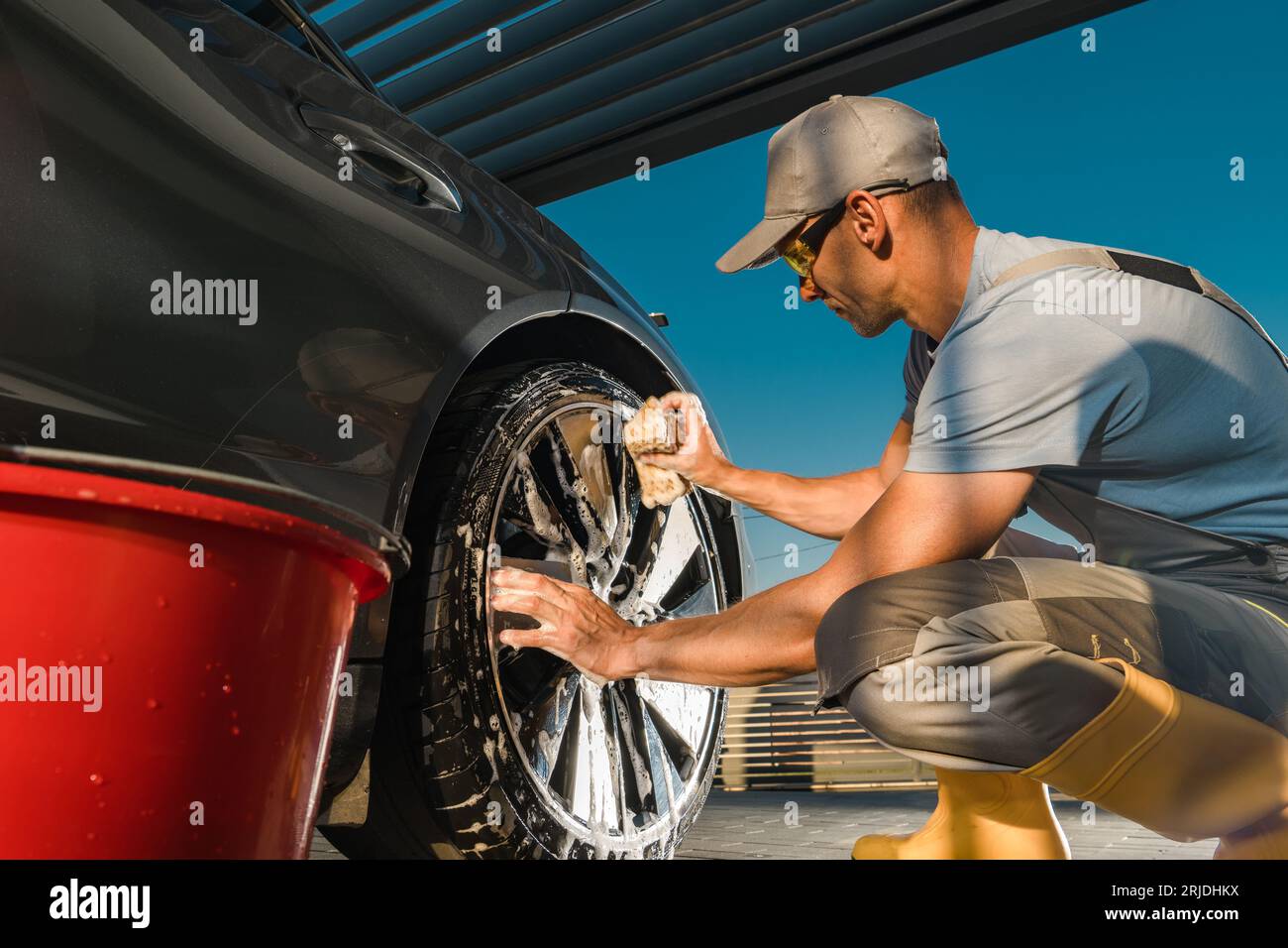 Caucasian Worker Cleaning Modern Vehicle Alloy Wheels Using Pro ...