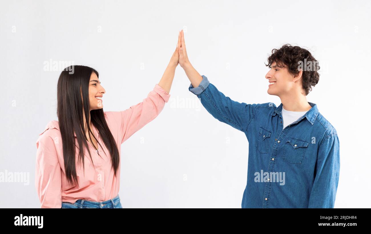 Happy Young Hispanic Couple Giving High Five Over White Background ...