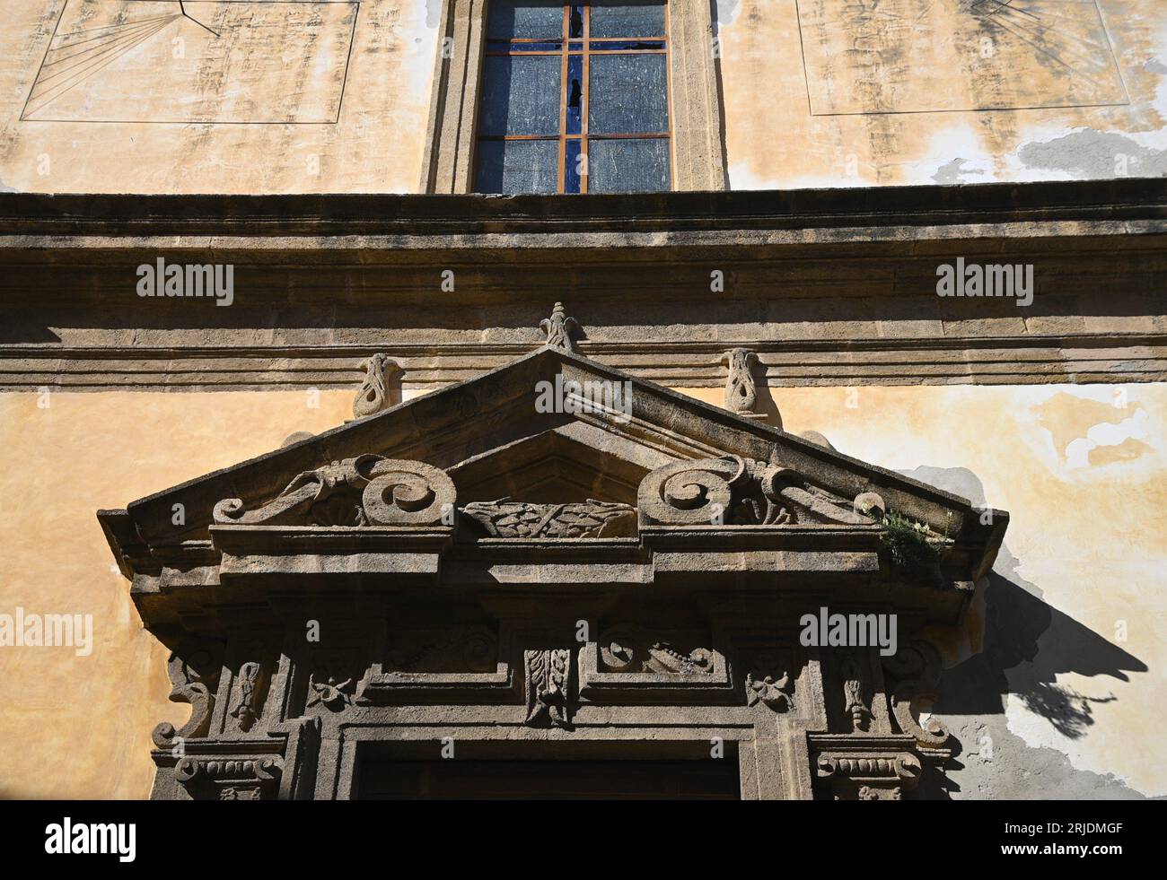 Antique Sicilian Baroque style pediment and solar clock on a stucco ...
