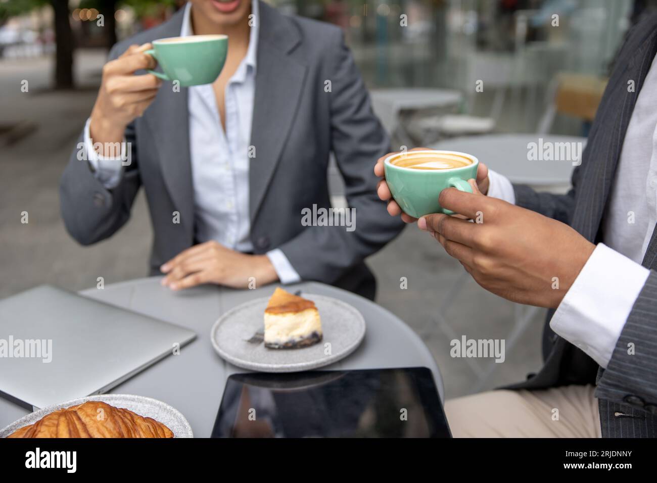 Business partners having coffee together Stock Photo - Alamy