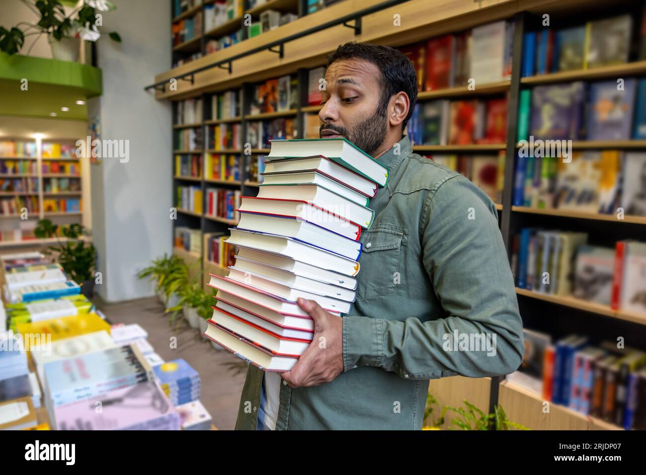 Young man carrying books Stock Photo - Alamy