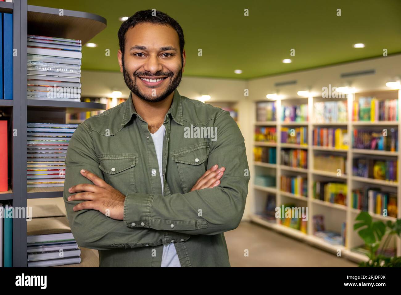 Dark-skinned man standing in the library Stock Photo - Alamy