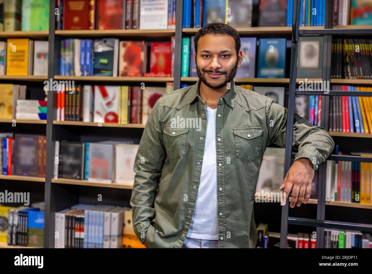 Dark-skinned man standing in the library Stock Photo - Alamy