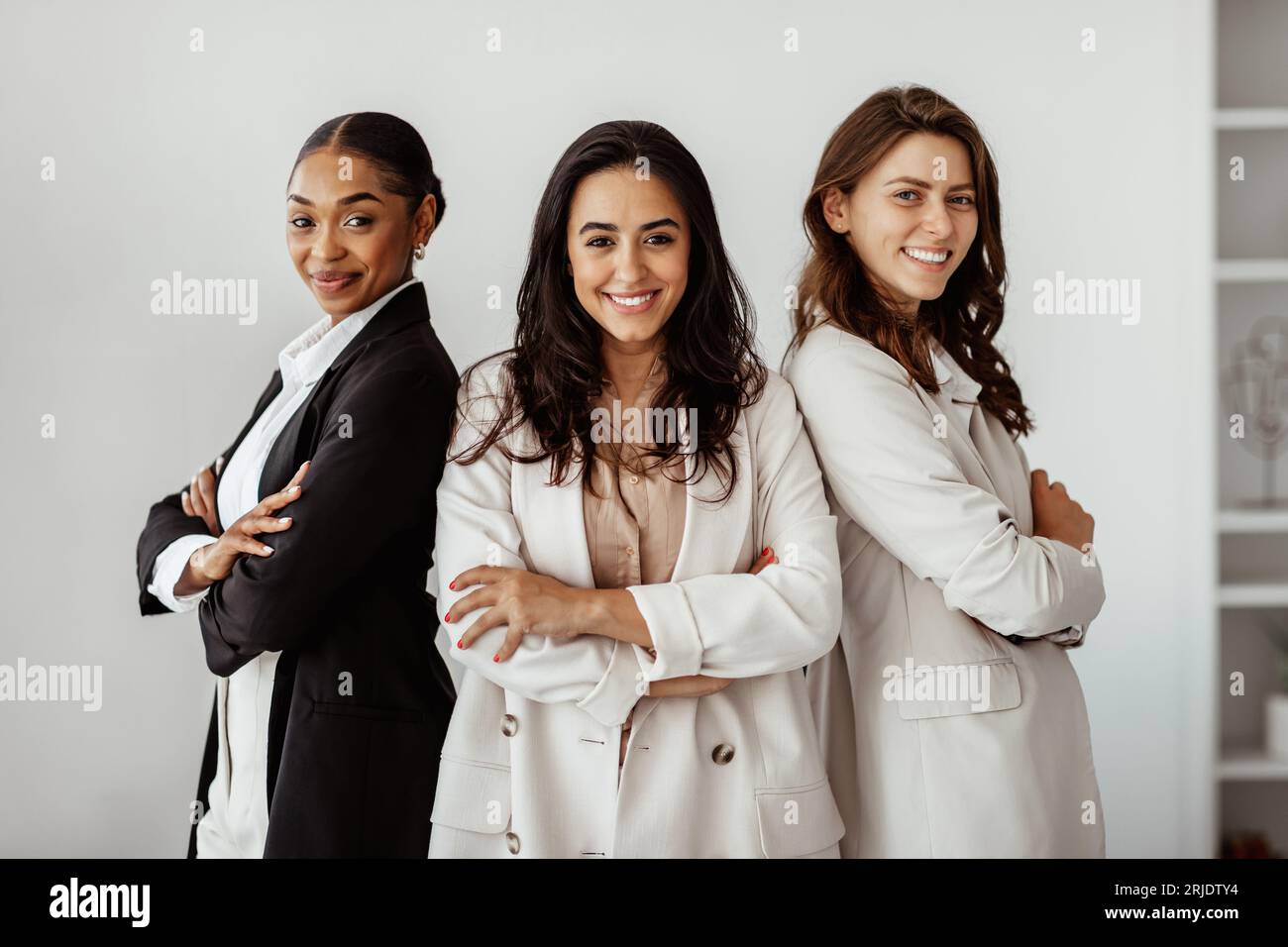Business team. Three diverse female colleagues in formal outfits ...