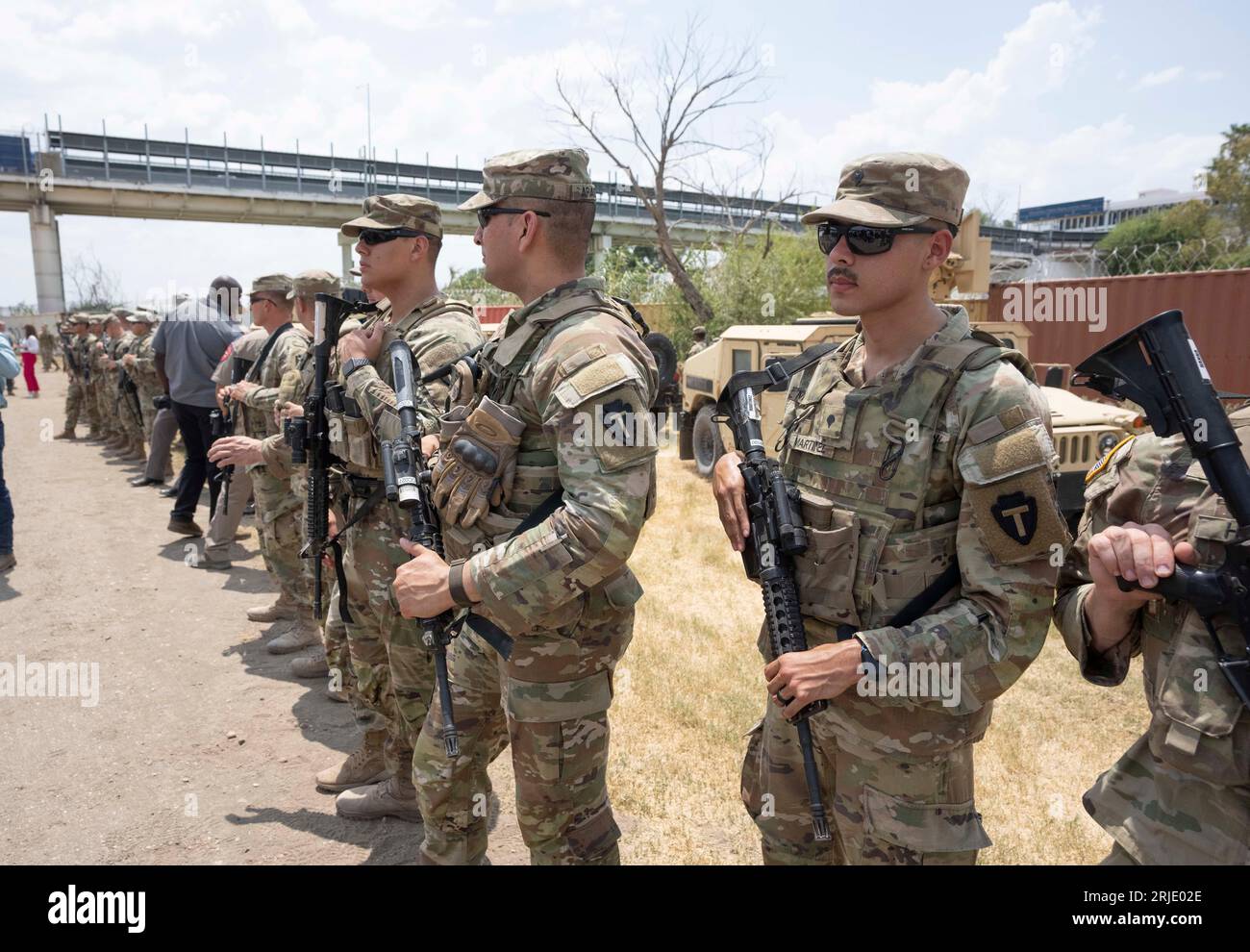 National Guard troops line the riverbank as several U.S. governors hold ...