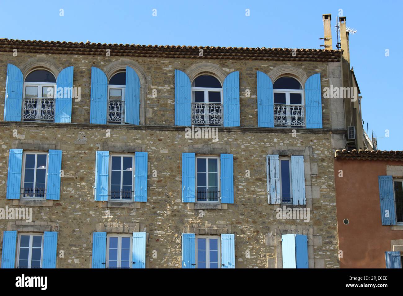 Blue shutters on the exterior of a building in the heart of Châteauneuf ...