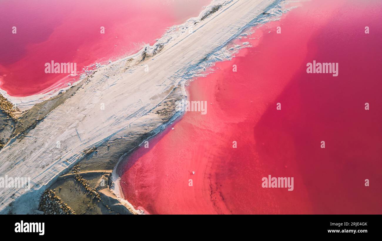 Aerial view of pink salt lake. Salt production plants evaporated brine ...