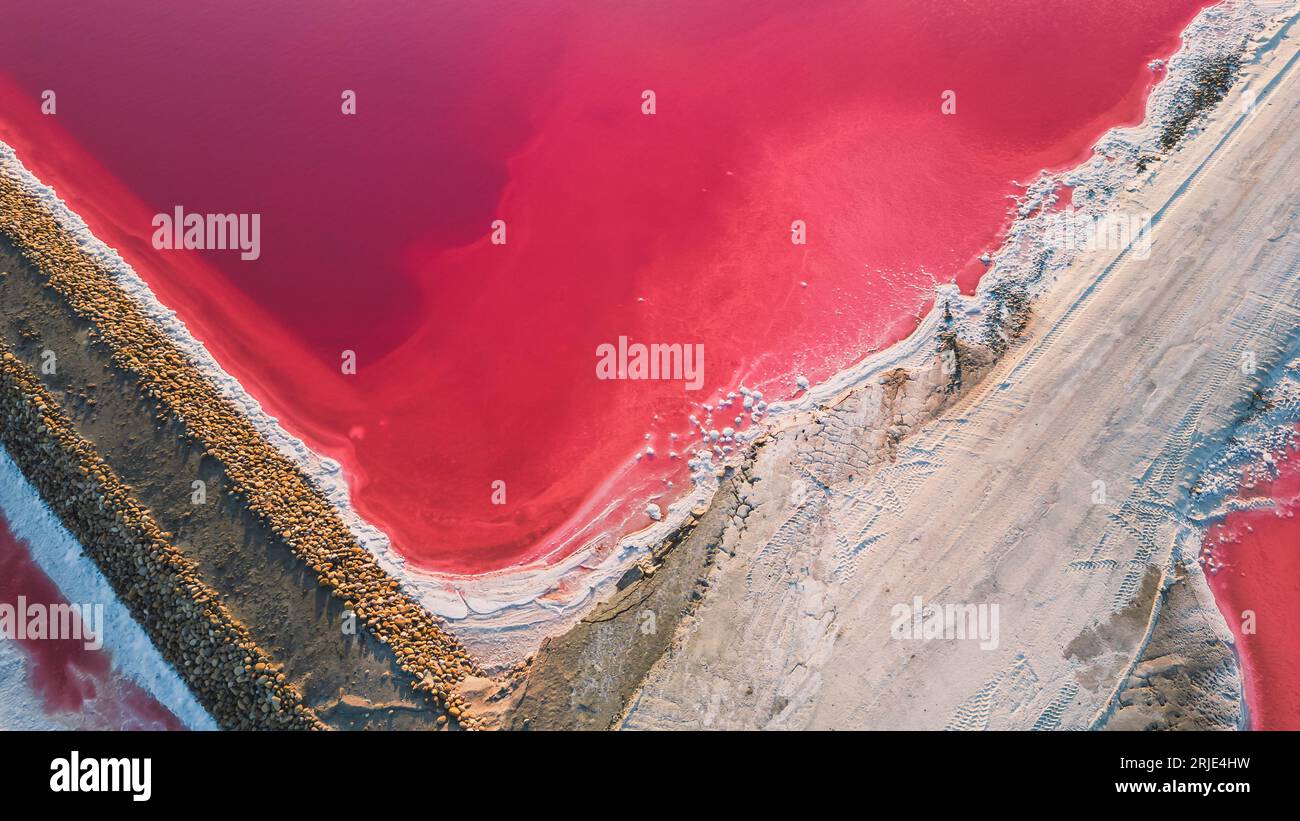 Aerial view of pink salt lake. Salt production plants evaporated brine ...
