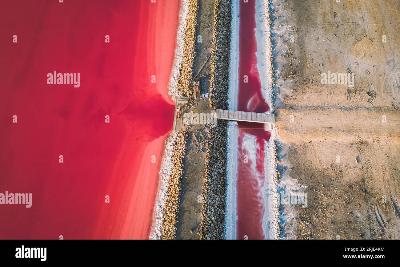 Aerial view of pink salt lake. Salt production plants evaporated brine ...