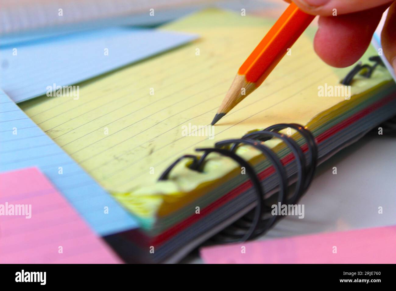 A photo of a school student putting their pencil to a colourful bundle ...
