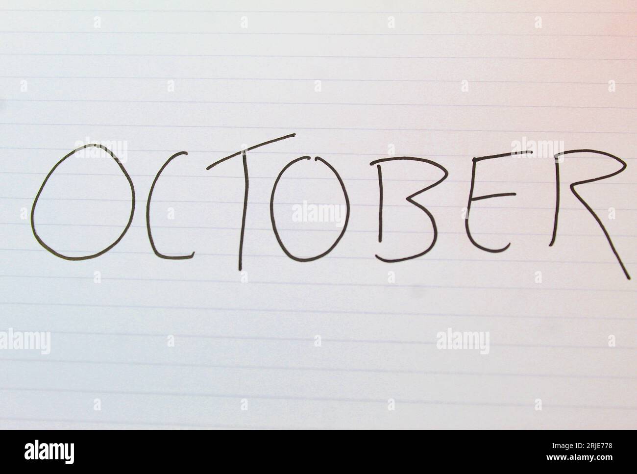 A photo of the month October written onto a white lined page Stock ...