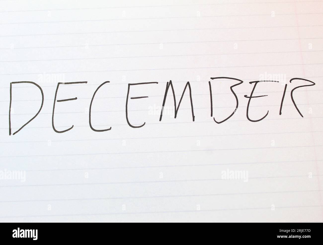 A photo of the month December written onto a white lined page Stock ...
