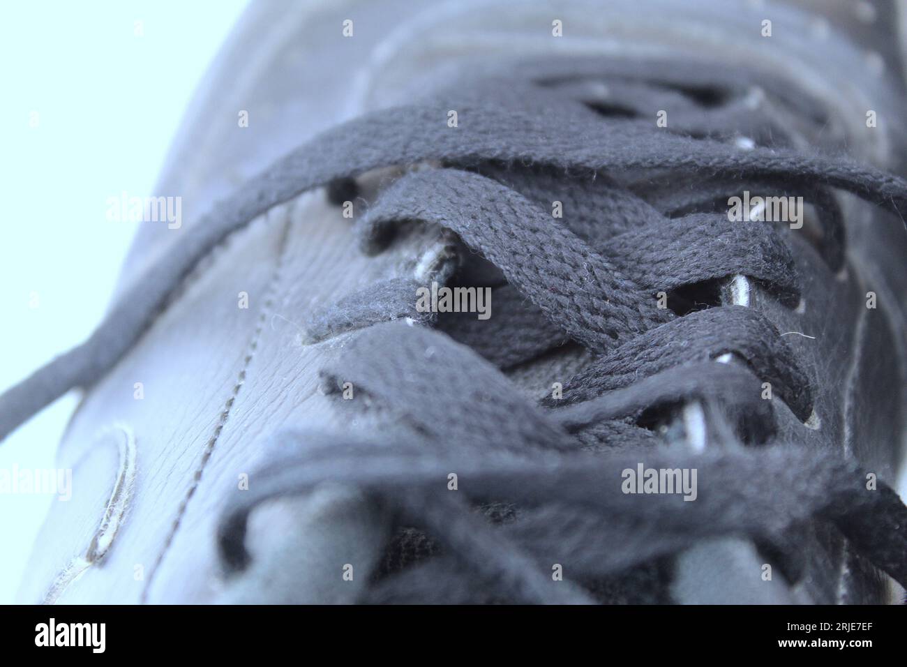 A photo of a student's school black shoe laces against a white ...