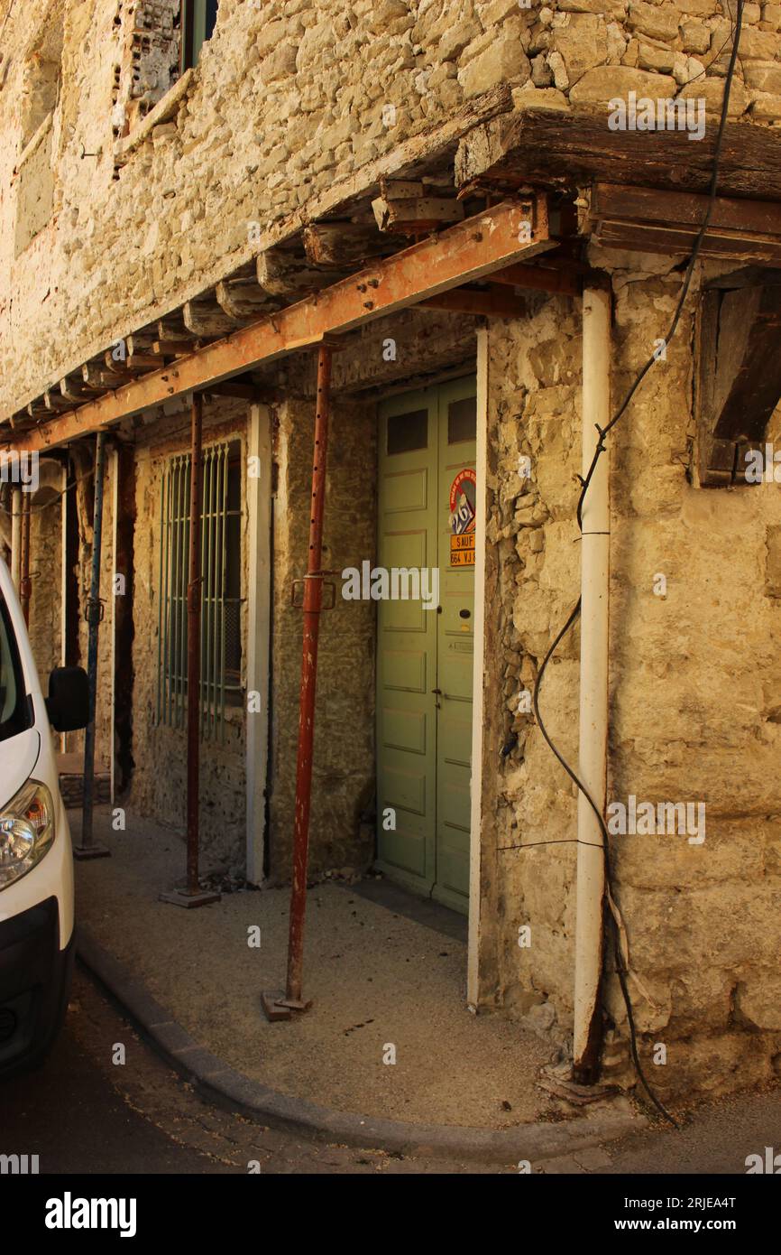 very old medieval stone building with wooden beams needing to be held ...
