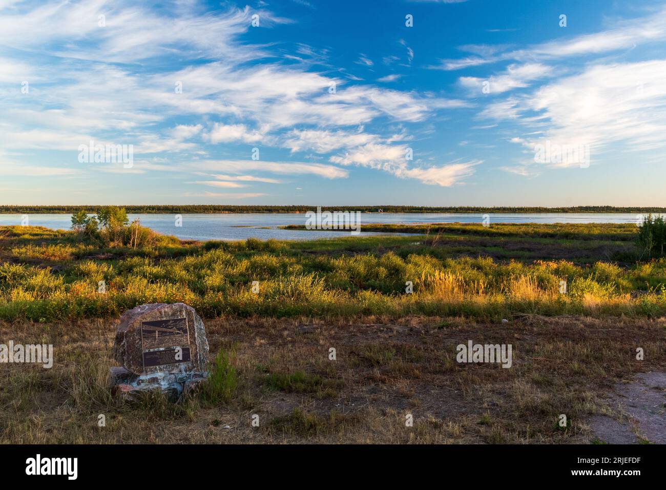 A dedication plaque for the Deh Cho Bridge, with the Mackenzie River in ...