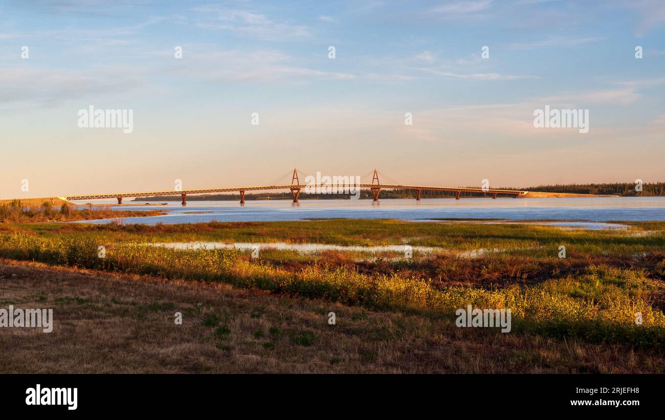 Golden Pink Sunset Colors glow on the Deh Cho Bridge across the ...