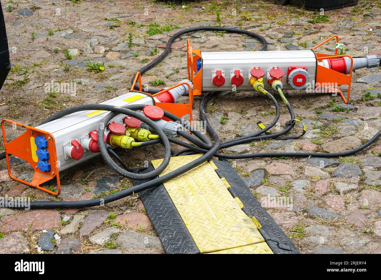 Plugged sockets on stone pavement, outdoor event temporary mobile power ...