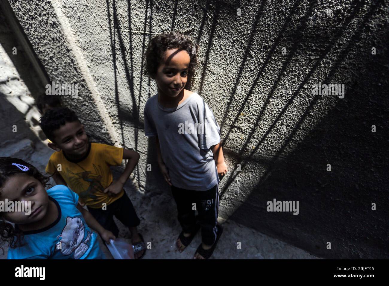 Palestinian children play outside their home in the Shati refugee camp ...