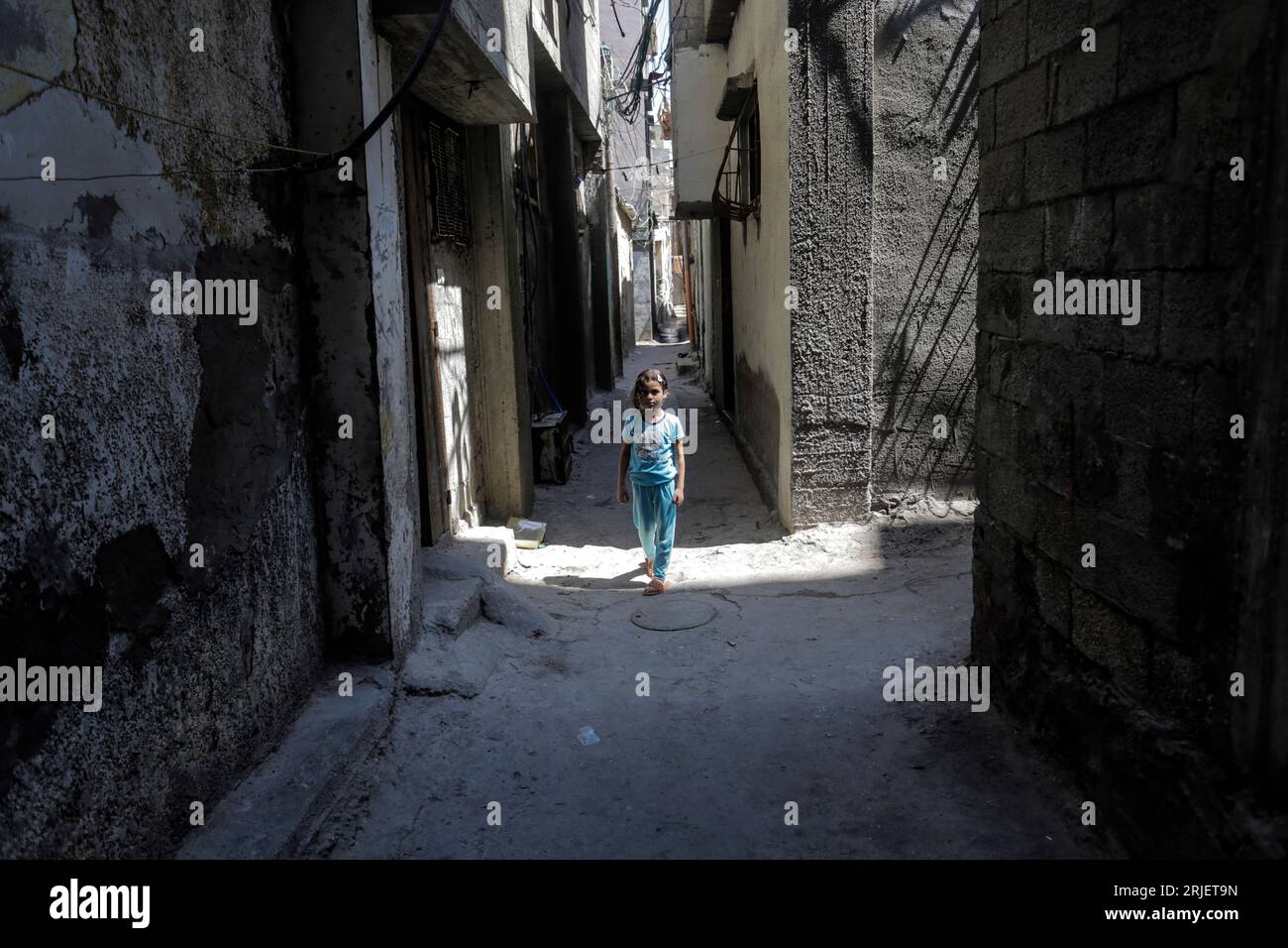 A Palestinian girl walks outside her home in Al-Shati refugee camp, the ...