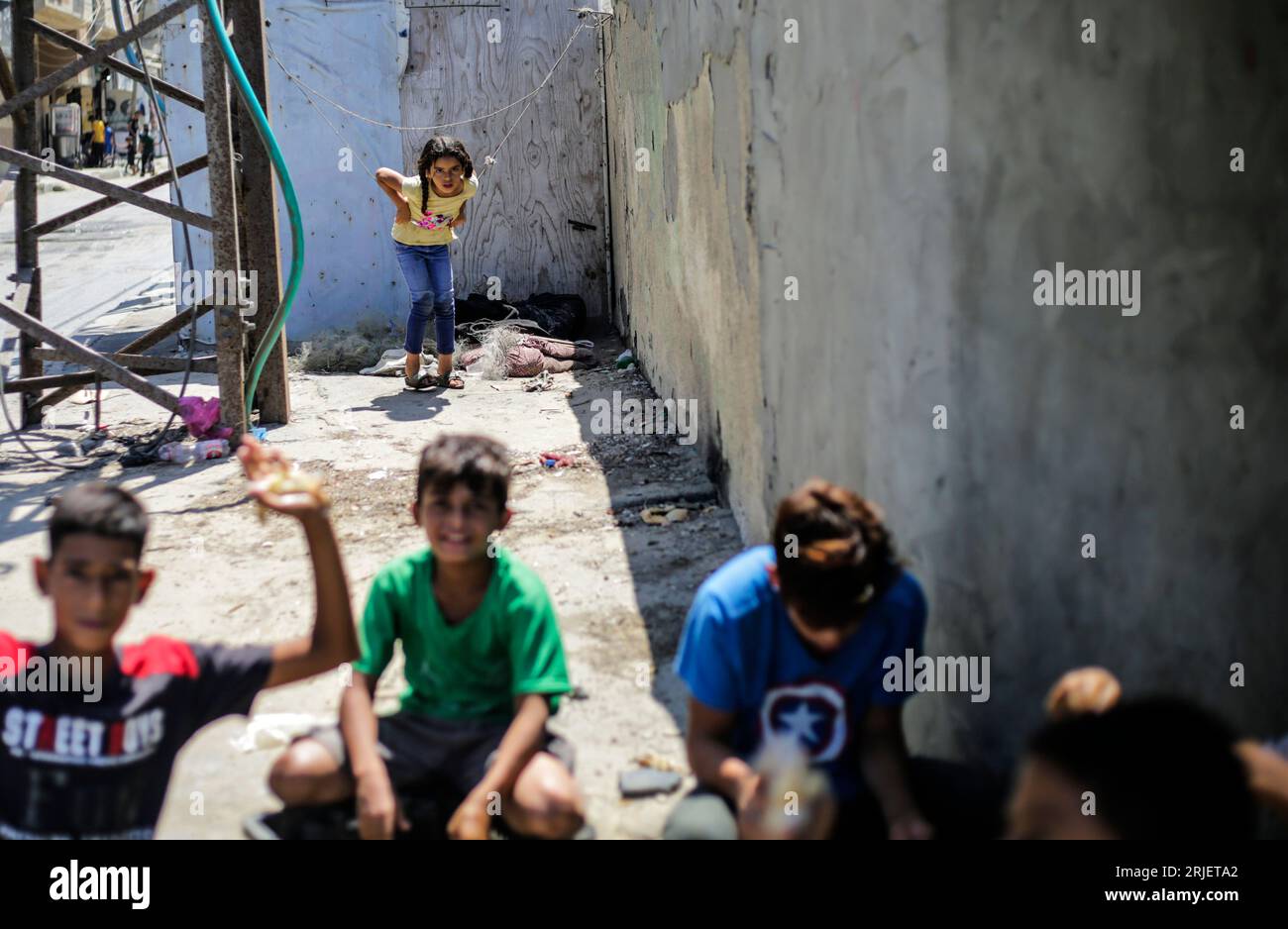 Palestinian children play outside their home in the Shati refugee camp, the third largest camp ...