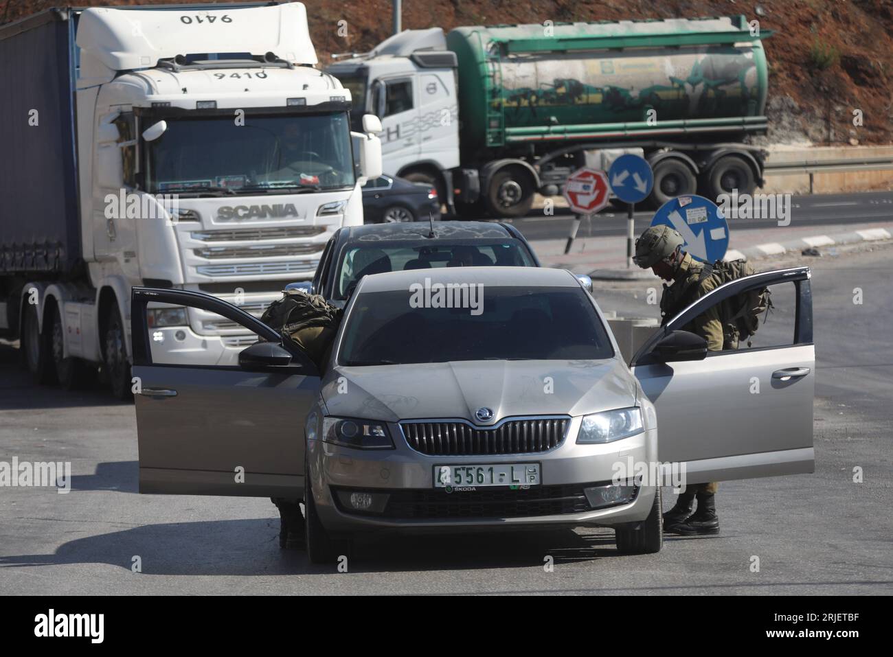 Hebron. 22nd Aug, 2023. Israeli soldiers check a vehicle at a ...