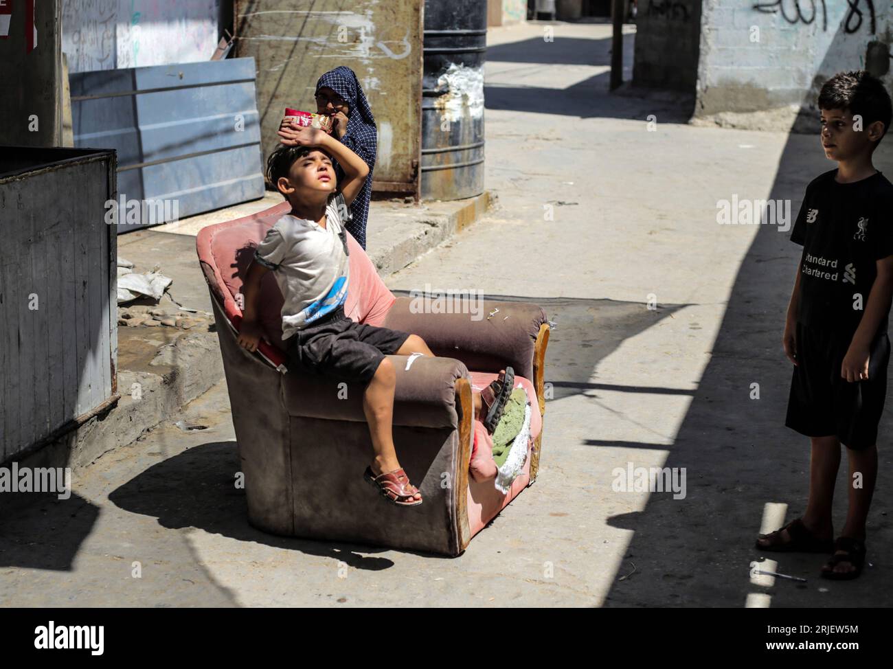 Gaza City, Palestine. 22nd Aug, 2023. A Palestinian child sits on a ...