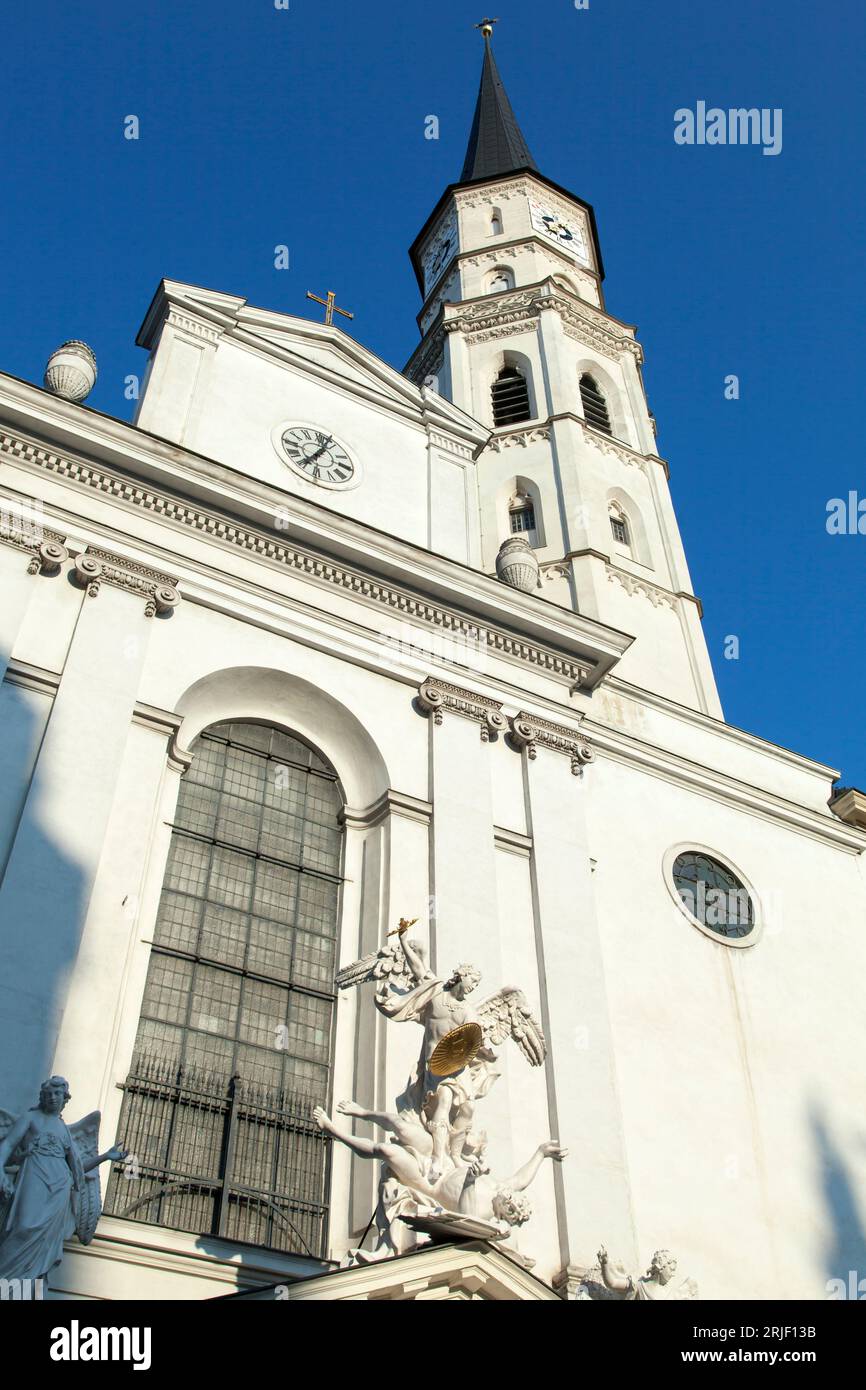 The evening view of 19th century catholic church with sculptures and a ...