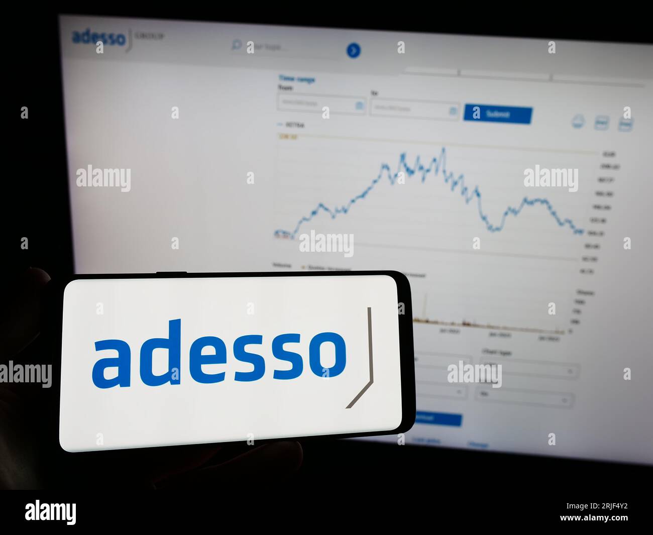 Person holding mobile phone with logo of German consulting company ...