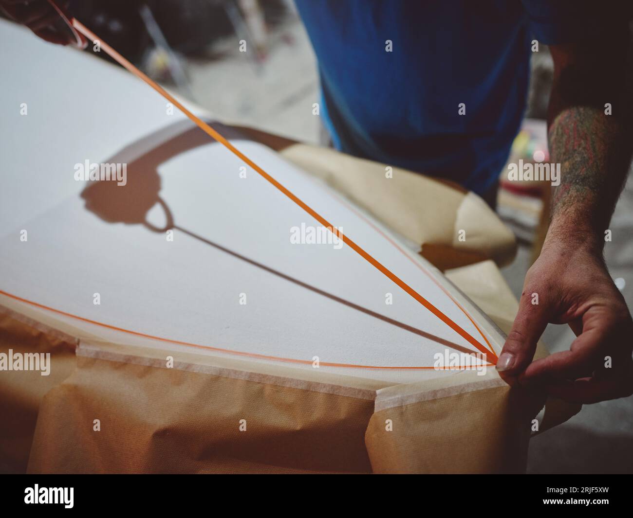 From above of crop anonymous male master putting decorative element on ...