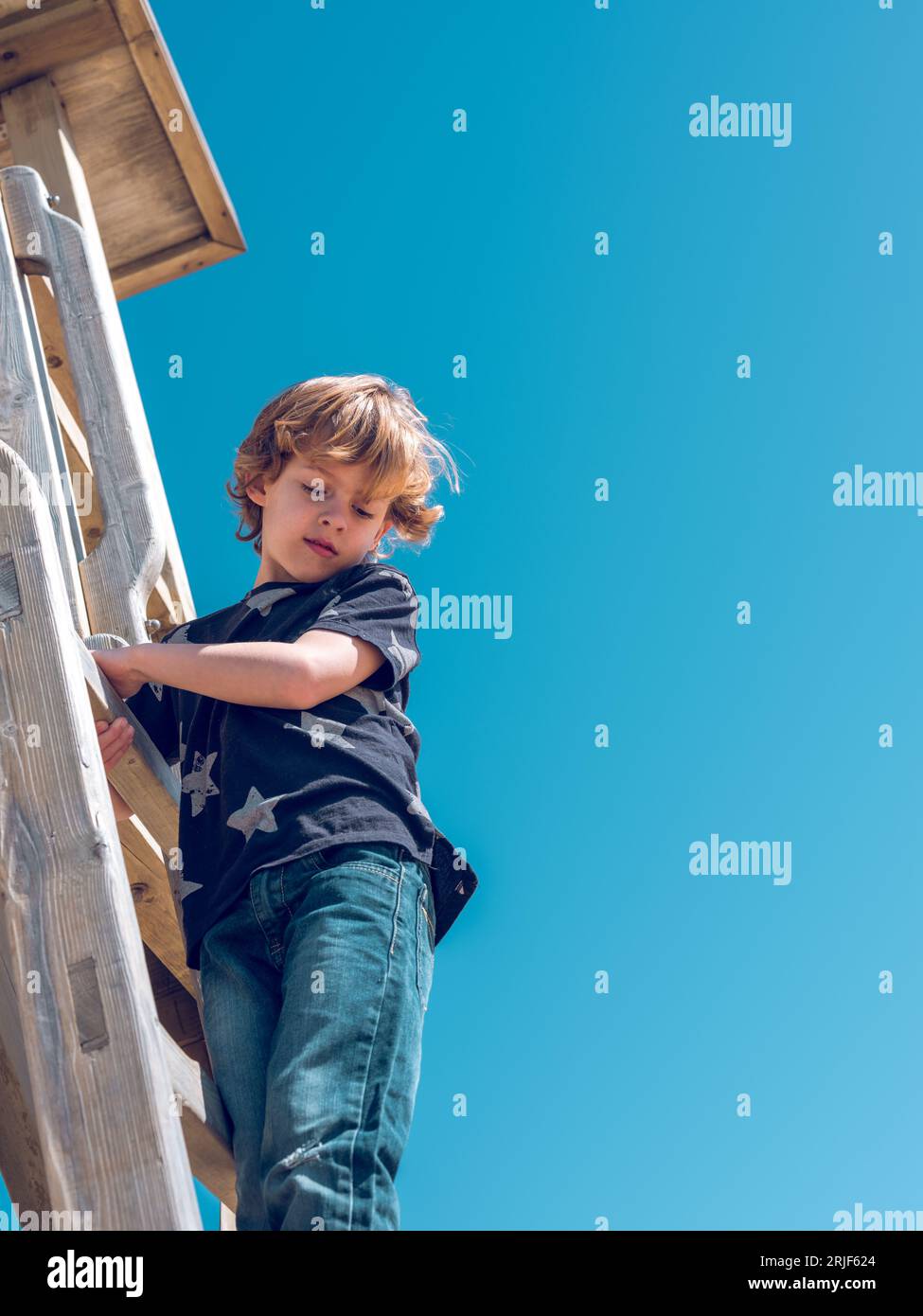Child standing alone in playground hi-res stock photography and images ...
