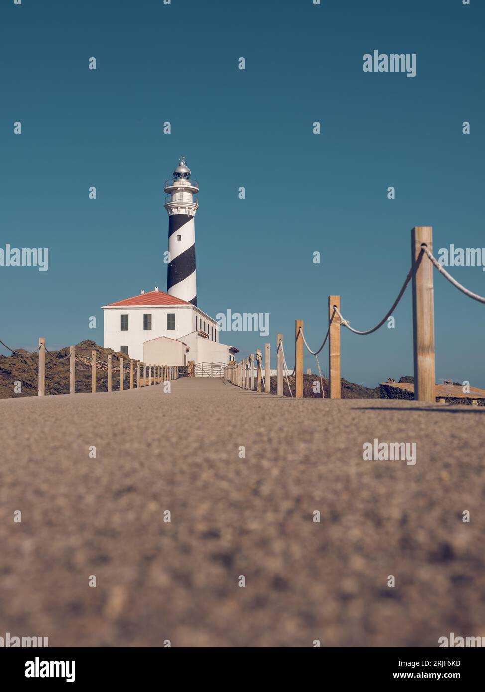 Ground level of empty walkway leading to small lighthouse located in ...