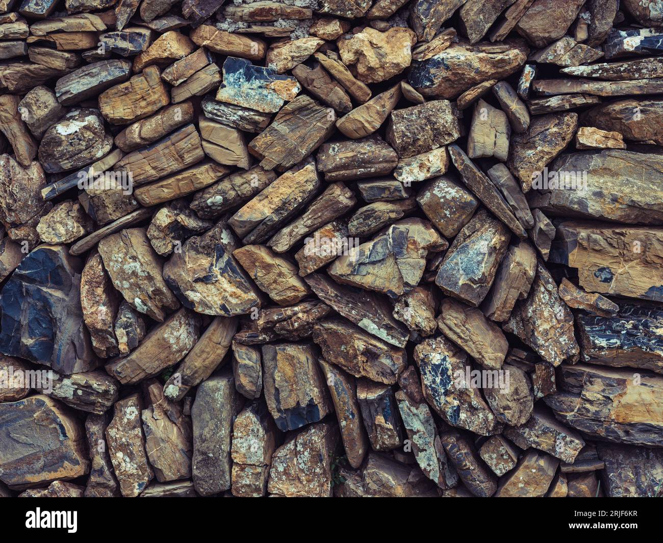 Full frame of rows of big hard boulders in pile placed in countryside ...