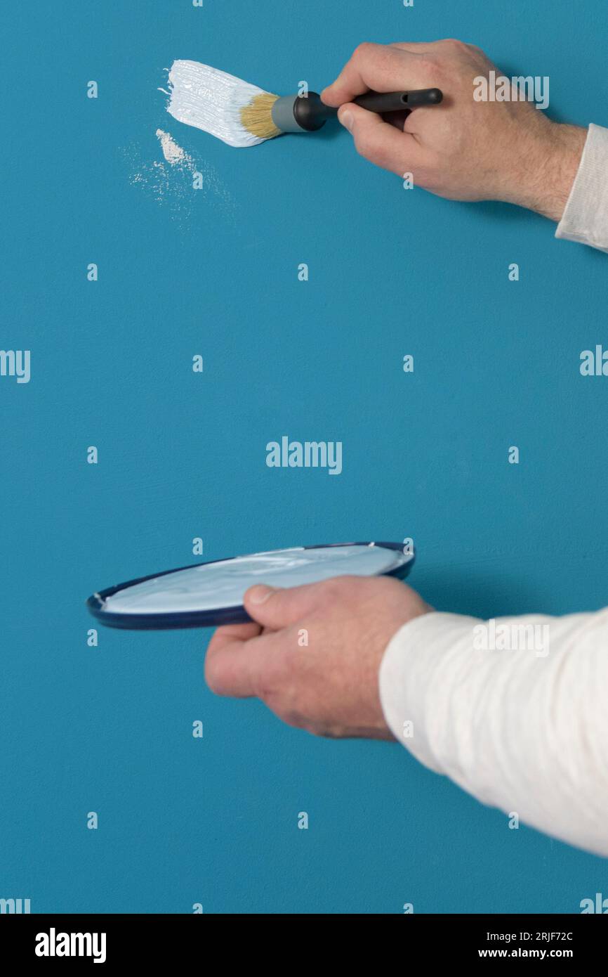 Worker smears white paint on hi-res stock photography and images - Alamy