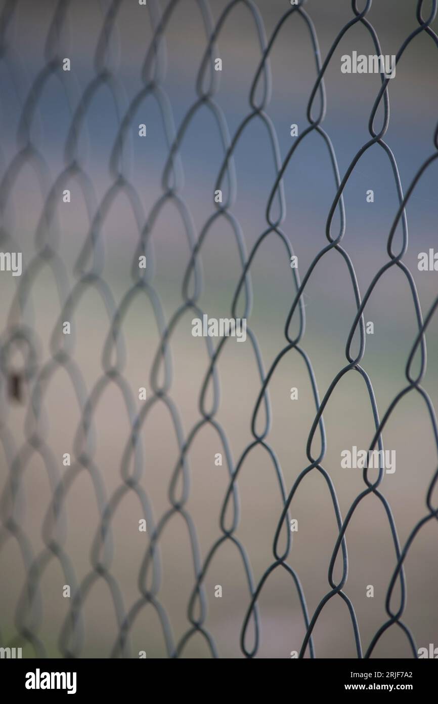 Geometric mesh of a wire to divide two properties Stock Photo - Alamy