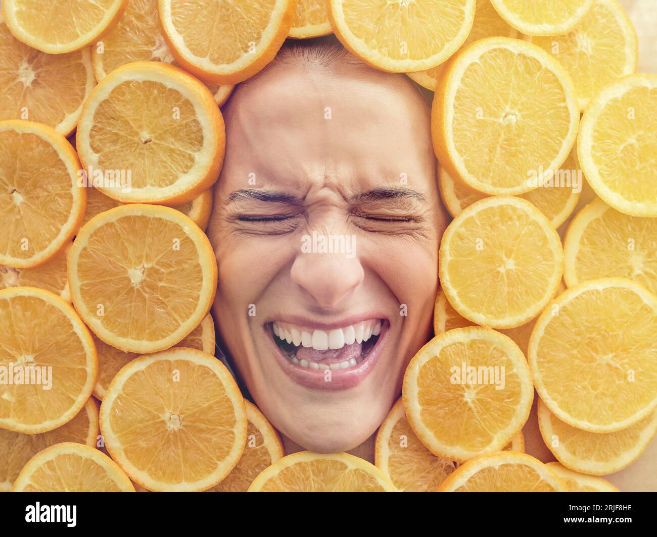 Overhead face of scared female frowning and shouting in large heap of ...