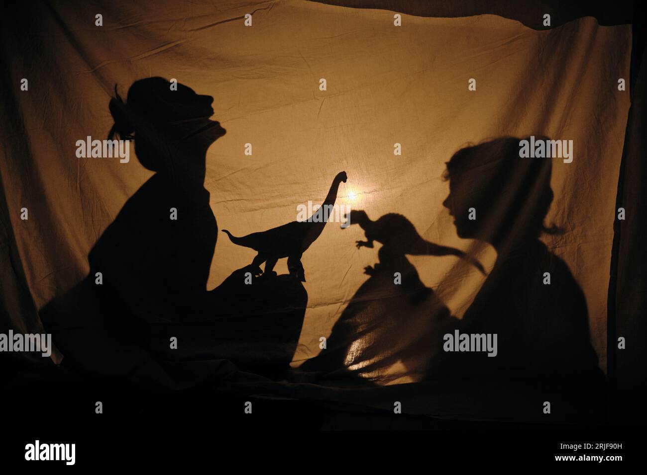 Silhouette of laughing mother playing with cute son and storytelling ...