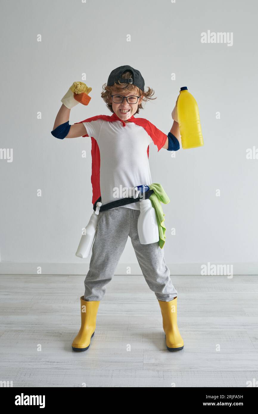 Full body of cheerful boy in colorful janitor costume and glasses ...