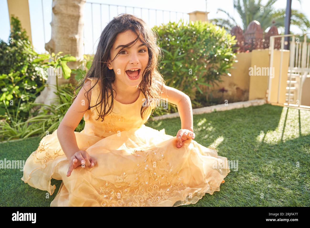 Ground level of mischievous preteen kid in elegant yellow dress ...