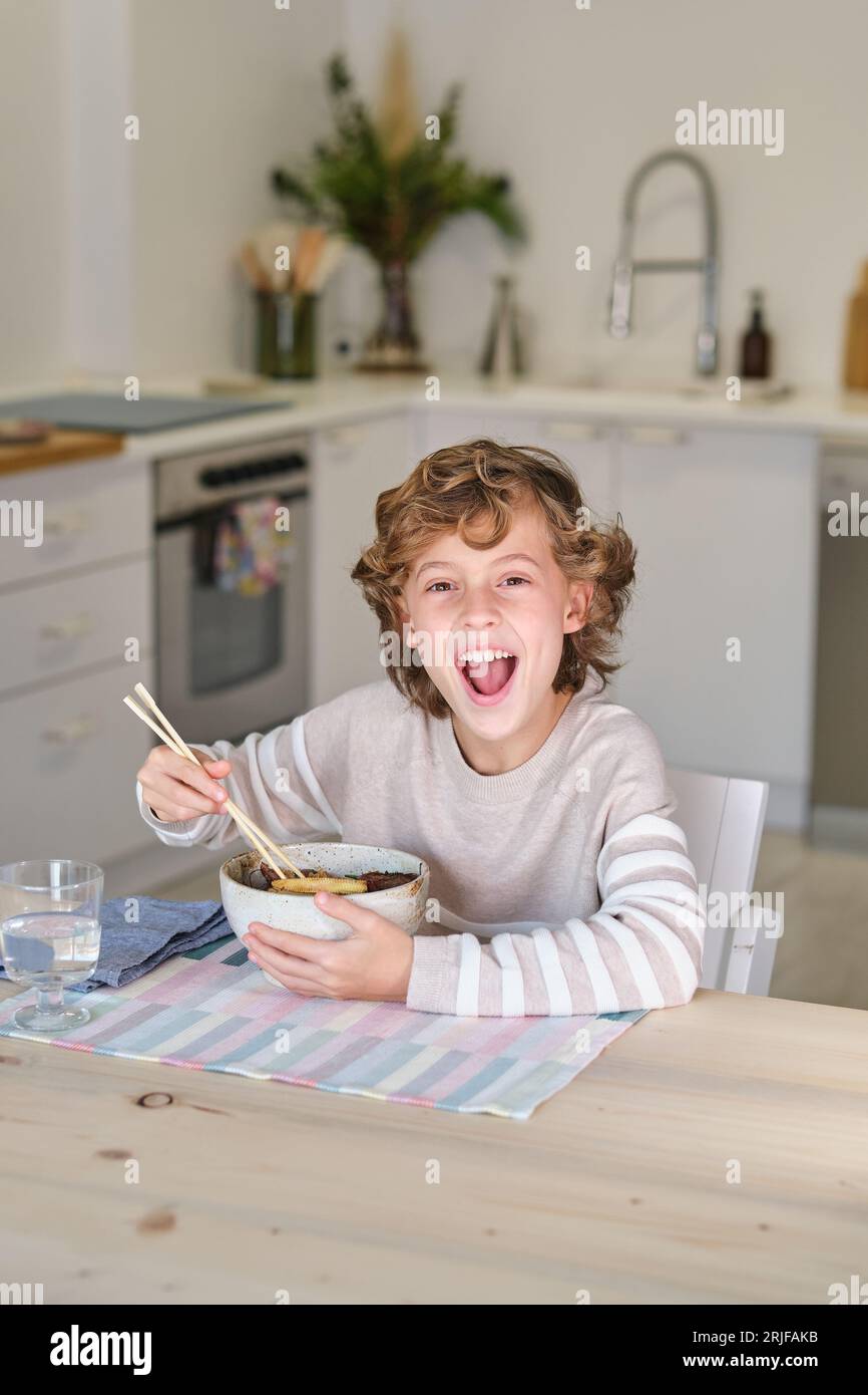 Chinese kid eating noodles hi-res stock photography and images - Alamy
